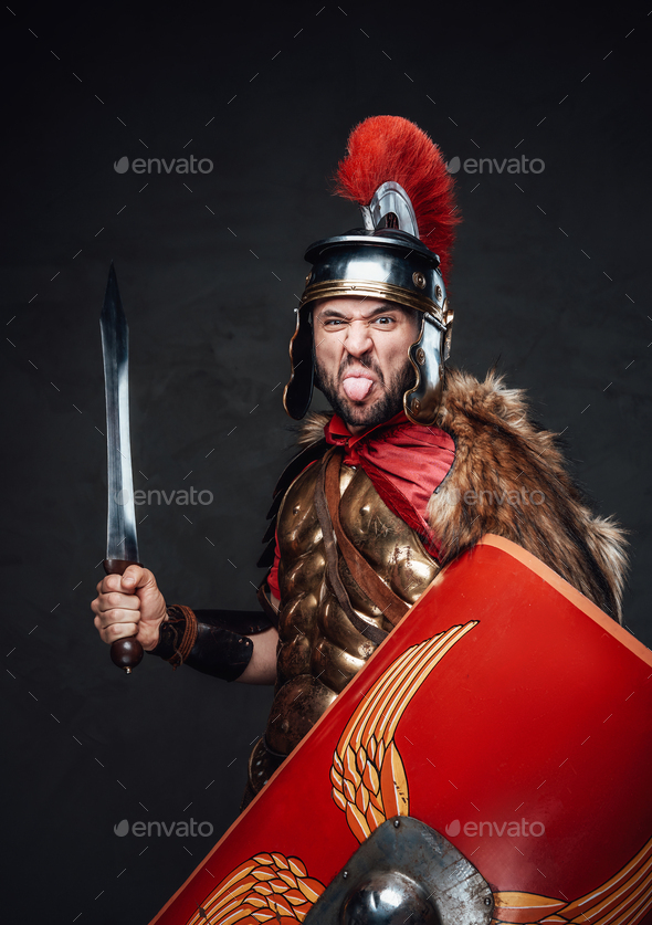 Funny roman soldier taunts his enemy against dark background Stock ...