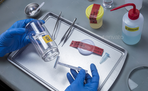 Forensic police take razor blade from victim in crime lab for analysis ...