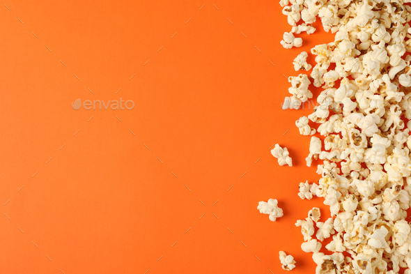Flat lay composition with popcorn on orange background, copy space ...