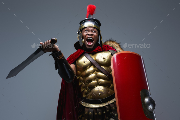 Screaming roman warrior assaults against gray background Stock Photo by ...