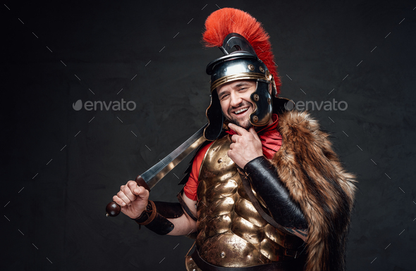 Smiling roman warrior with sword on his shoulder Stock Photo by fxquadro