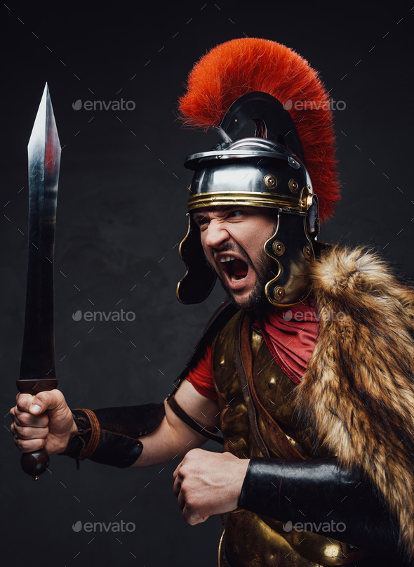 Crying military roman wielding sword against dark background Stock ...