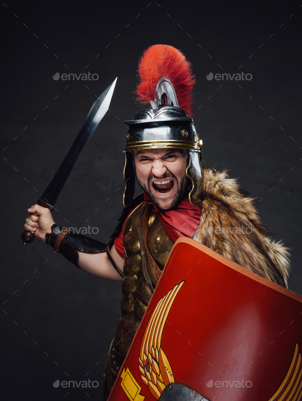 Violent roman soldier screams against dark background Stock Photo by ...