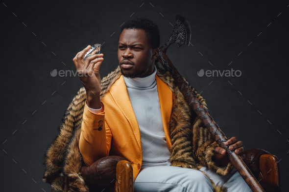 Bizarre african guy with huge axe and diamond Stock Photo by fxquadro
