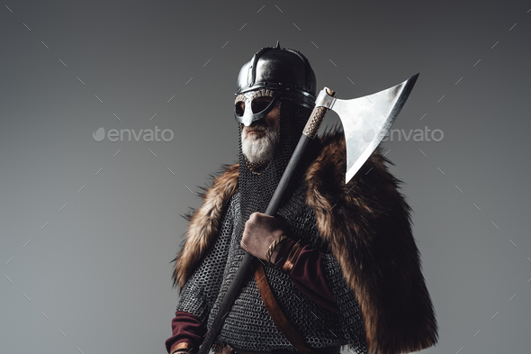 Side view studio shot of old man viking with axe Stock Photo by fxquadro