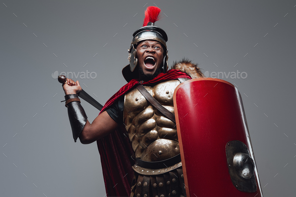 Violent roman warrior in fight pose with sword Stock Photo by fxquadro