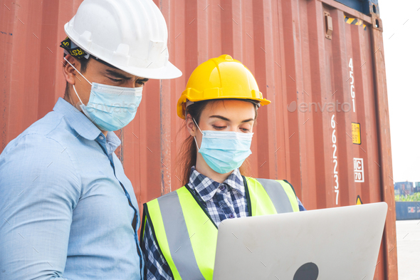 Engineer foreman using laptop working and discussing with female worker ...