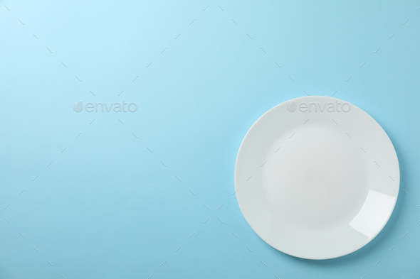 Plate on blue background, top view and space for text Stock Photo by ...