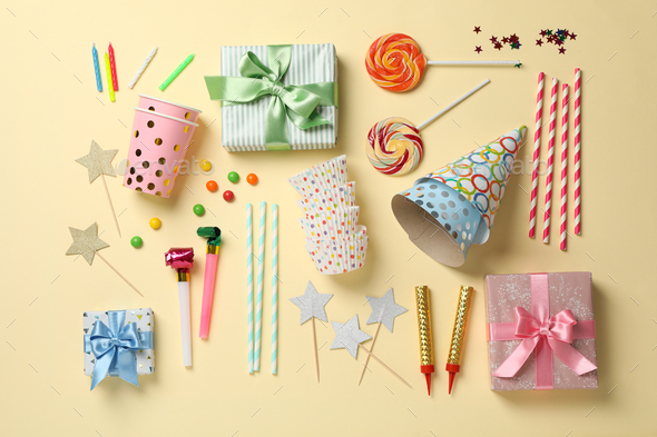 Composition with different birthday accessories on beige background ...