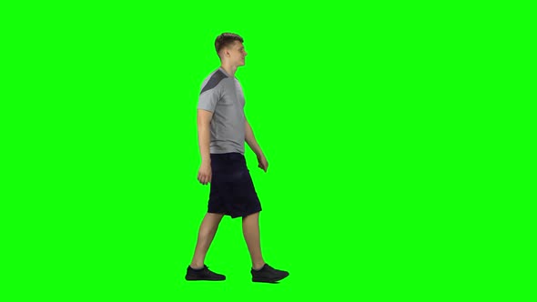 Young Man Walking on a Green Screen. Profile Side View, Stock Footage