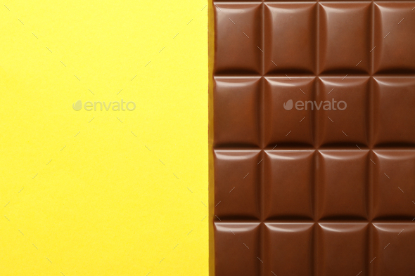 Tasty chocolate bar on yellow background. Sweet food Stock Photo by ...