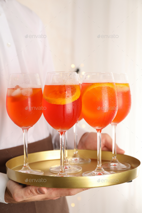 Waiter holding tray with aperol spritz cocktail. Summer drink Stock ...