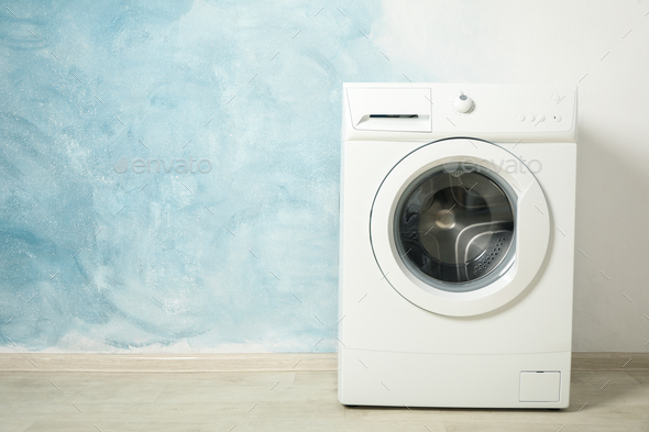 Modern washing machine against blue background, space for text Stock ...
