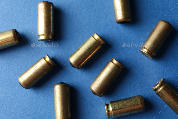 Rubber bullets on blue background, top view. Self defense weapon Stock ...