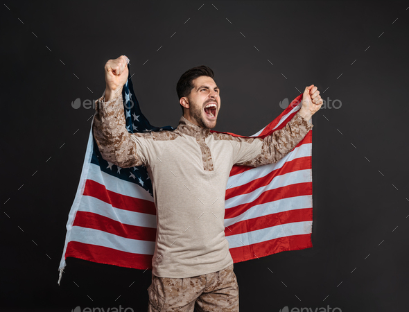 Excited military man screaming while posing with american flag Stock ...