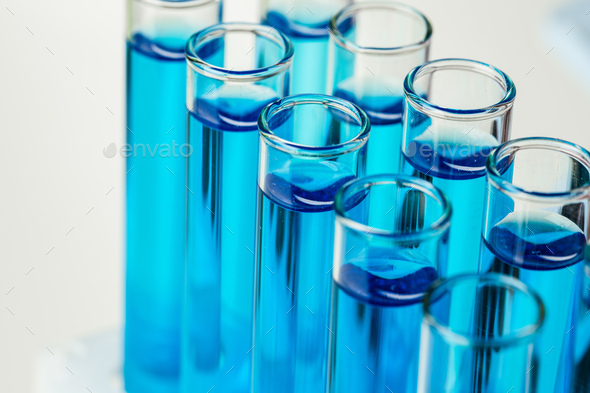 Laboratory test tubes with blue liquid close up Stock Photo by FabrikaPhoto
