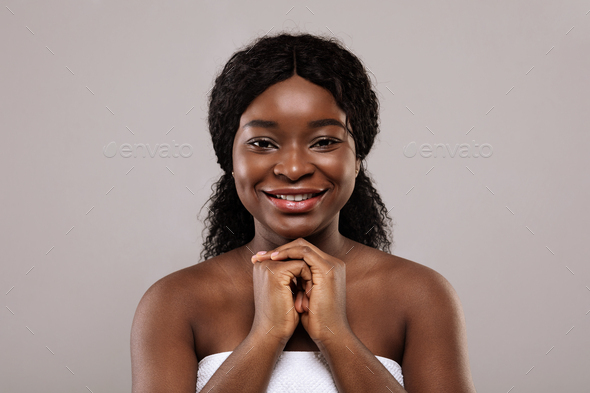 Facial Treatments. Portrait of attractive smiling black woman with ...
