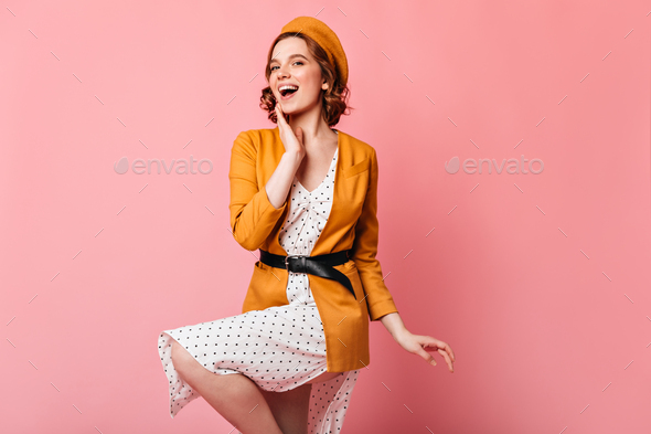 Graceful french girl dancing on pink background. Studio shot of ...