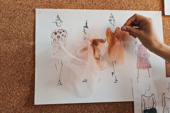 Lady creating dress samples with lace. Woman works as garments designer ...