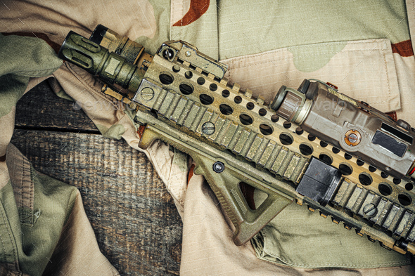 Close up photo of M16 rifle on wooden board Stock Photo by FabrikaPhoto