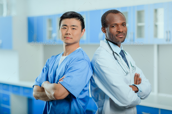 portrait of multiracial group of doctors in medical uniforms in clinic ...