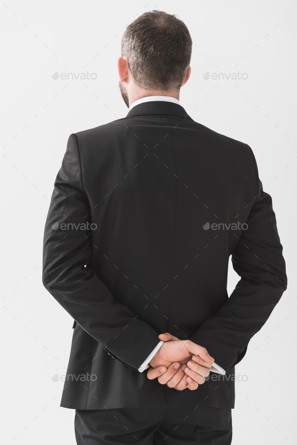 back view of businessman in black suit holding hands on back isolated ...