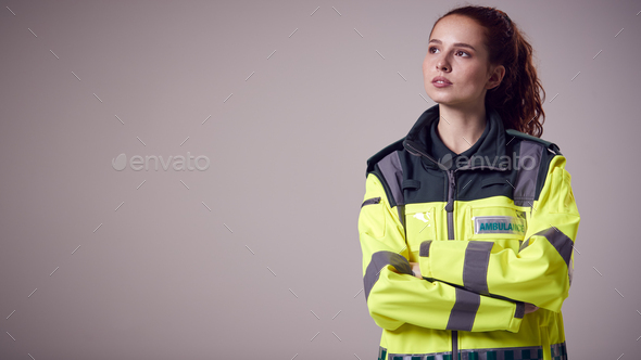 Studio Portrait Of Serious Young Female Paramedic Against Plain ...