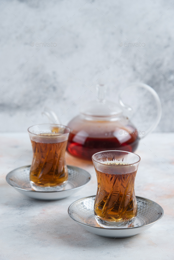 Vertical photo. Teapot and glass two glass tea on white background ...