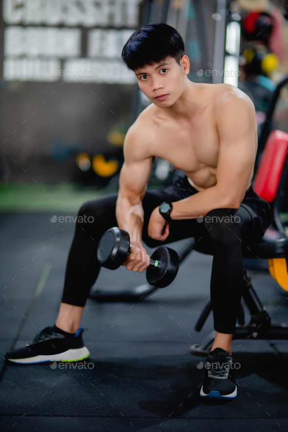 Young man bodybuilder lifting perform exercise with dumbbell Stock ...