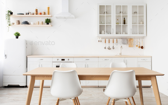 Scandinavian interior design. Light kitchen furniture and dining table ...