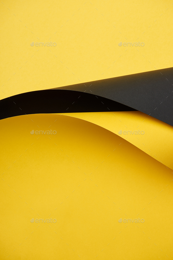 close-up view of beautiful bright yellow and black paper background ...