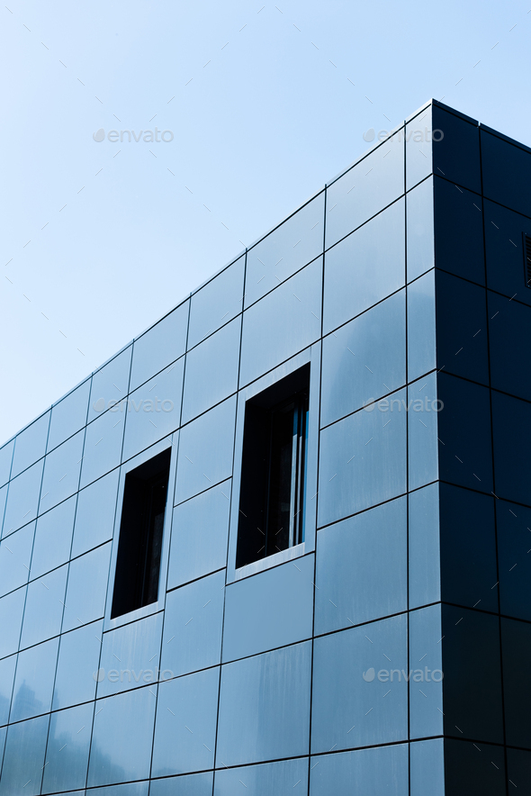 Modern glass building on sky background Stock Photo by LightFieldStudios