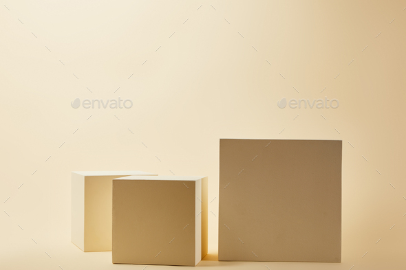 still life of cubes in various sizes on beige surface Stock Photo by ...