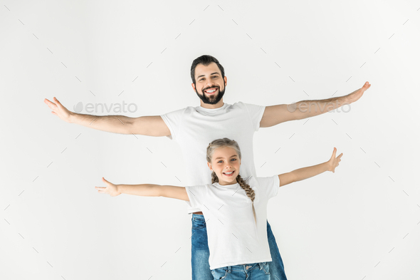 happy father and daughter standing with open arms and smiling at camera ...