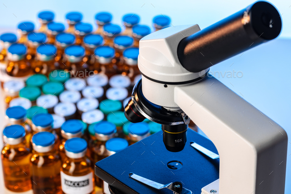 Medical vial with medication near microscope photo Stock Photo by ...