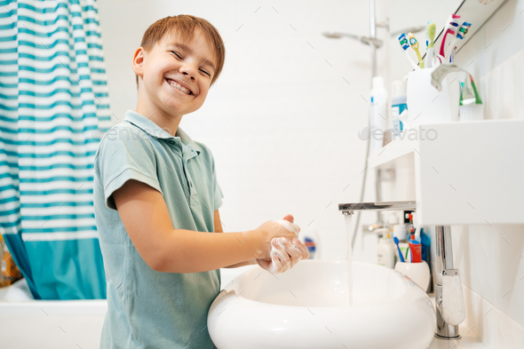 Smiling boy wash his hands with soap Stock Photo by diignat | PhotoDune