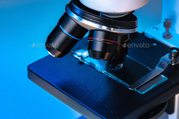 Microscope with lenses close up against dark background Stock Photo by ...