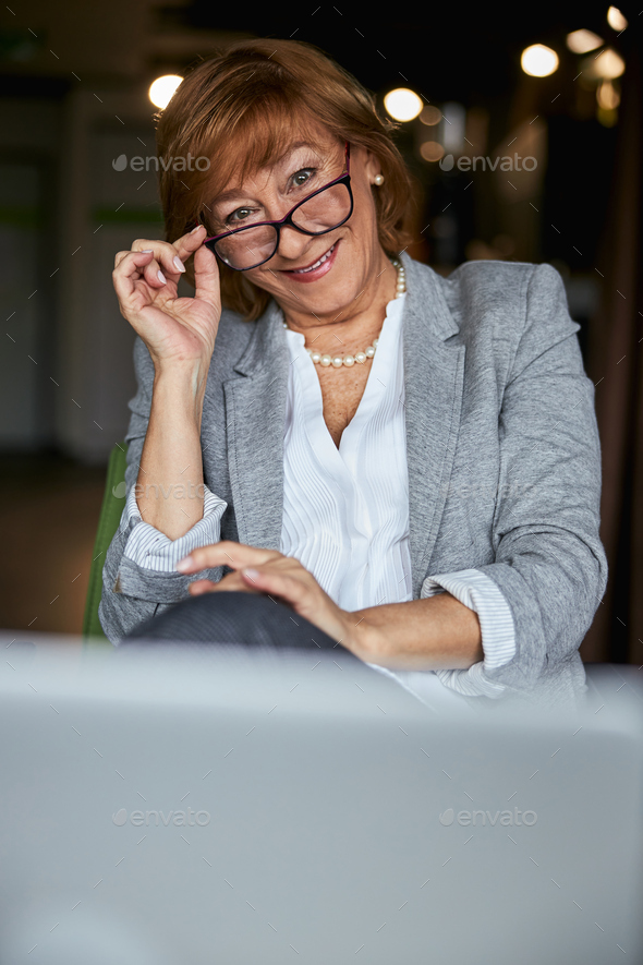Positive delighted female person posing on camera Stock Photo by Iakobchuk