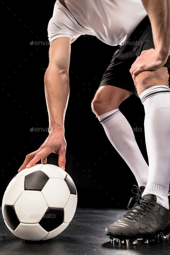 Soccer player lining a ball up for a kick Stock Photo by LightFieldStudios