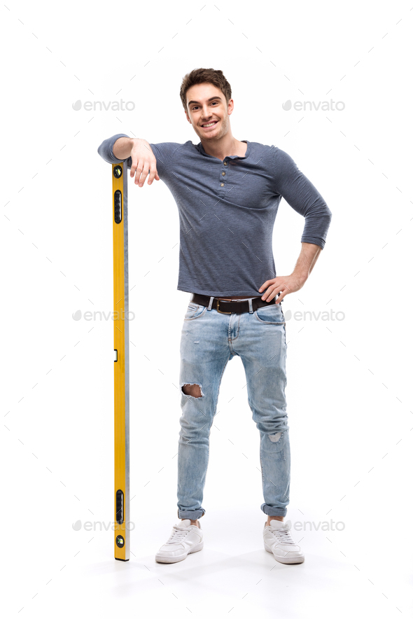 handsome man holding building level isolated on white, handyman tools ...