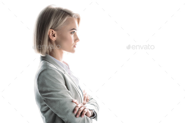side view of confident attractive businesswoman with crossed arms ...