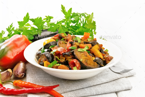 Ragout with eggplant and pepper on white board Stock Photo by rezkrr