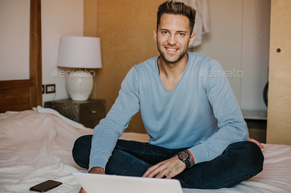 Handsome coworker man working at living room at home. Stock Photo by ...
