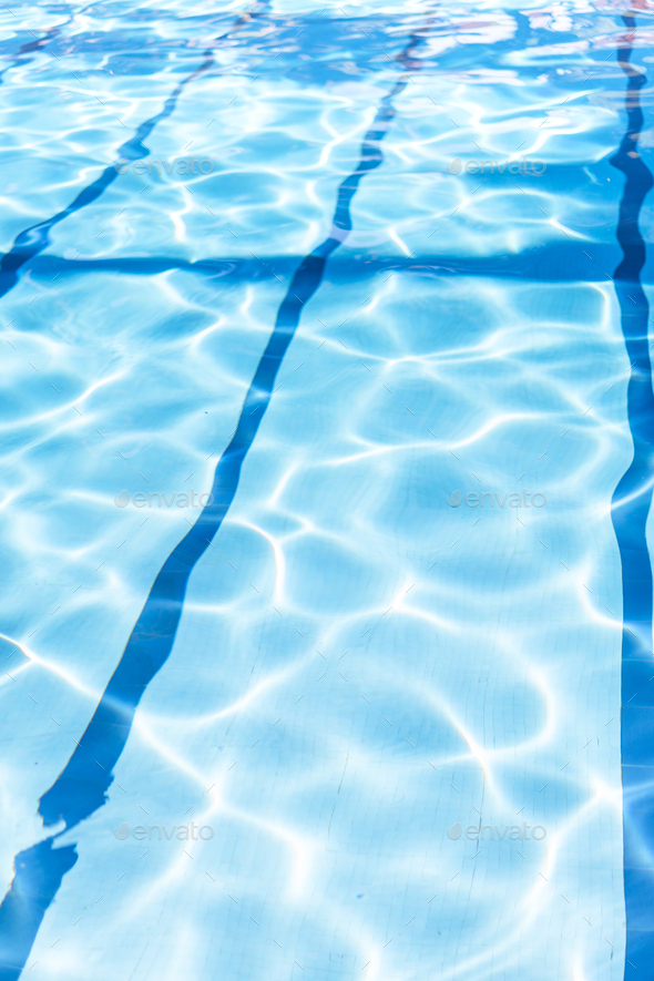 Ripple Water in swimming pool with sun reflection. Summer day at ...