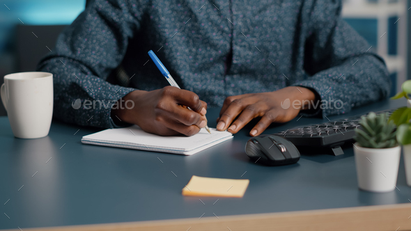Closeup african american black man hands taking notes on notepad using ...