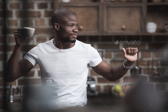 Handsome african american man having his morning coffee at home Stock ...