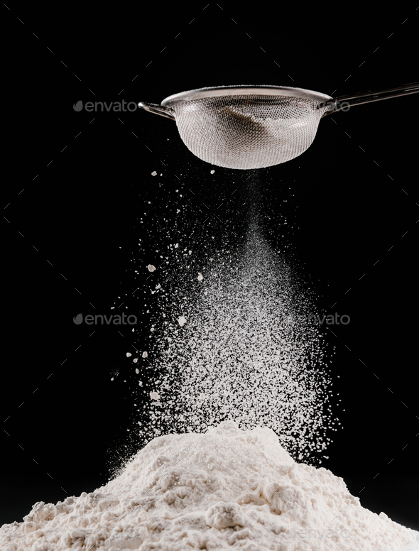 flour falling from sieve on pile isolated on black Stock Photo by ...