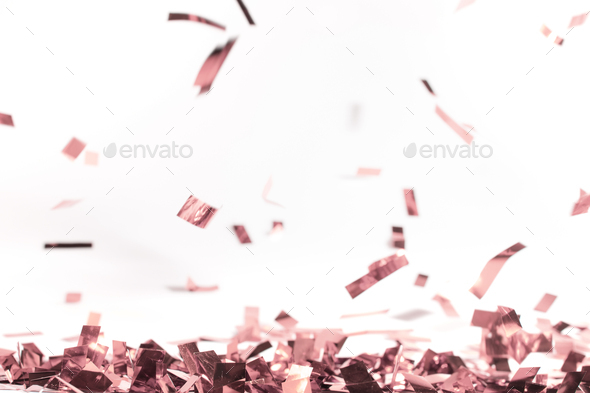 Muted pink falling confetti on white Stock Photo by LightFieldStudios