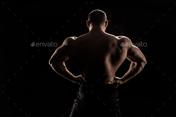 back view of young shirtless athlete flexing back muscles Stock Photo ...