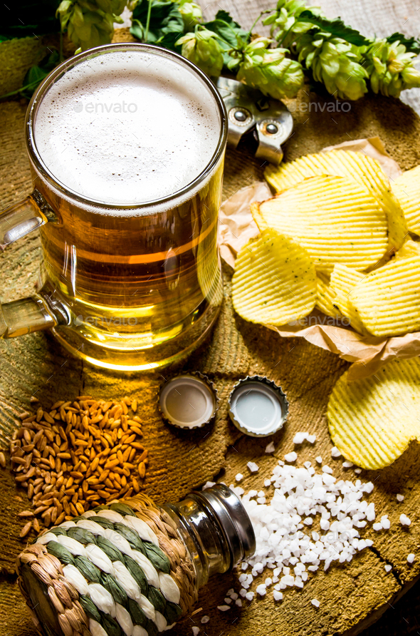 Beer rustic style . Beer and chips on wooden background. Stock Photo by ...